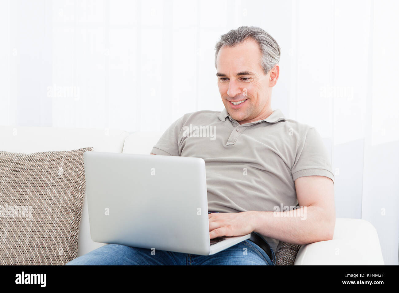 Mature man holding computer hi-res stock photography and images - Alamy