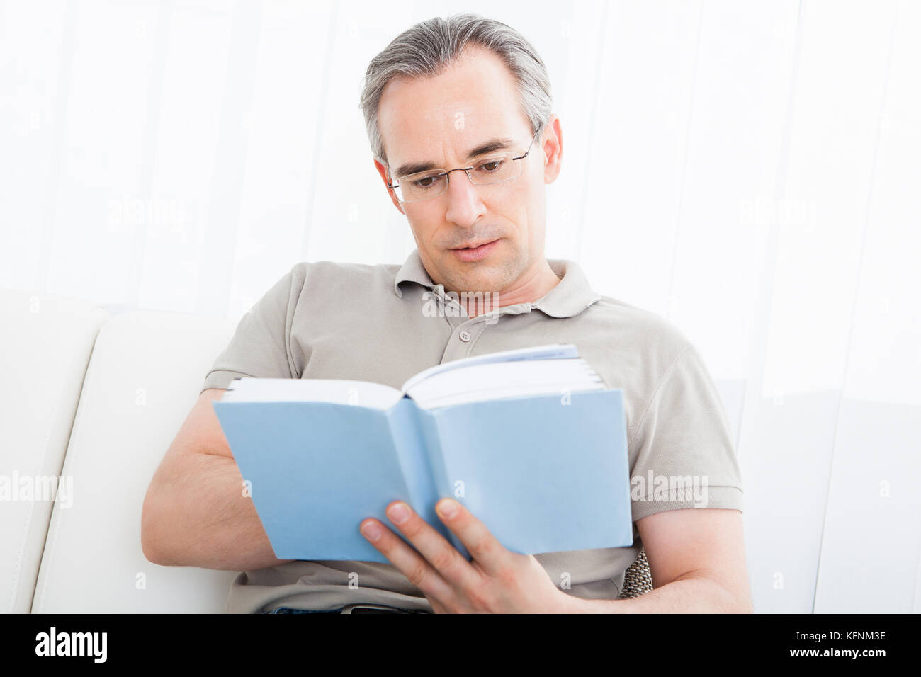 Portrait of mature man reading a book hi-res stock photography and ...