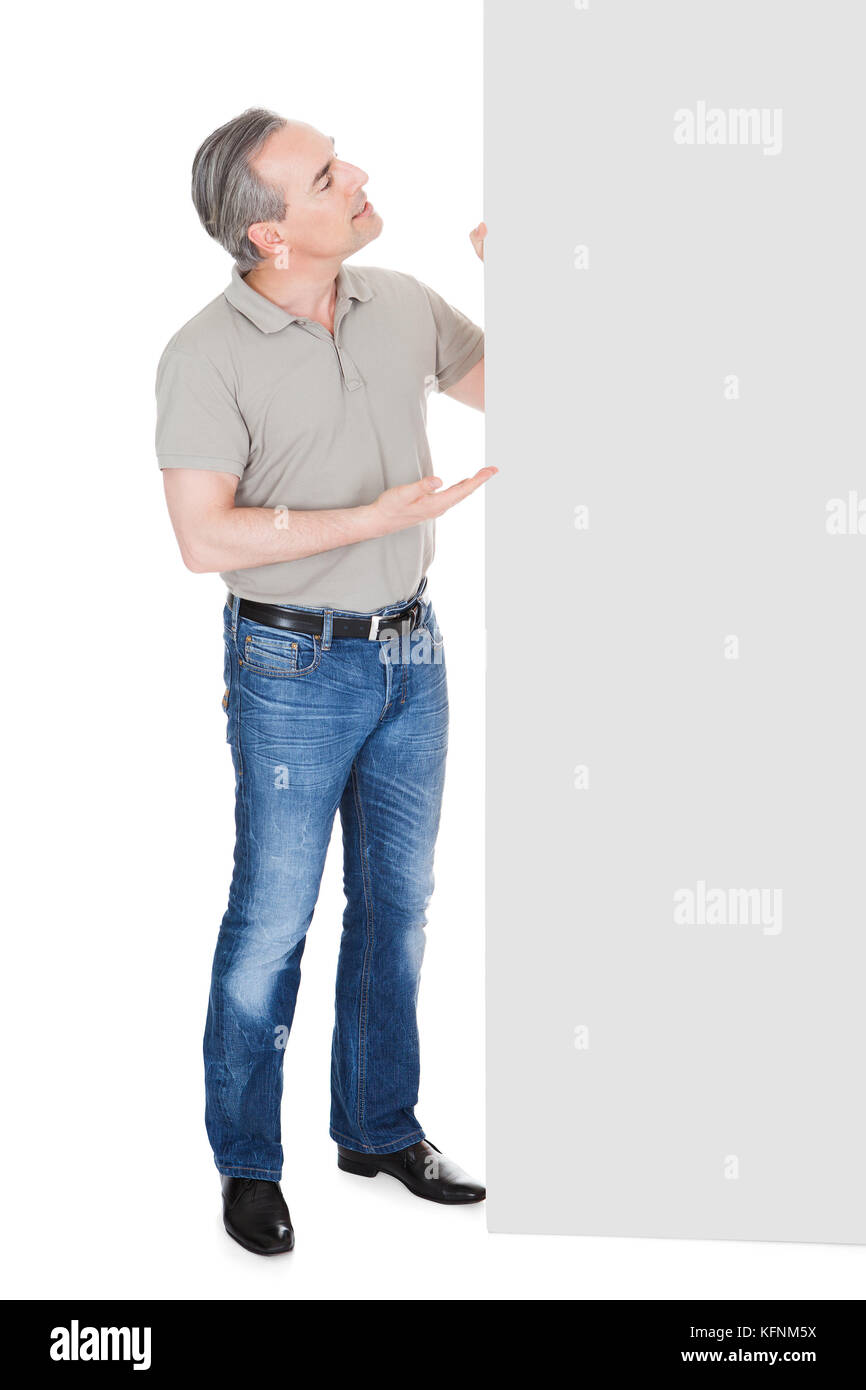 Happy Mature Man Standing Behind Placard isolated on White Background ...