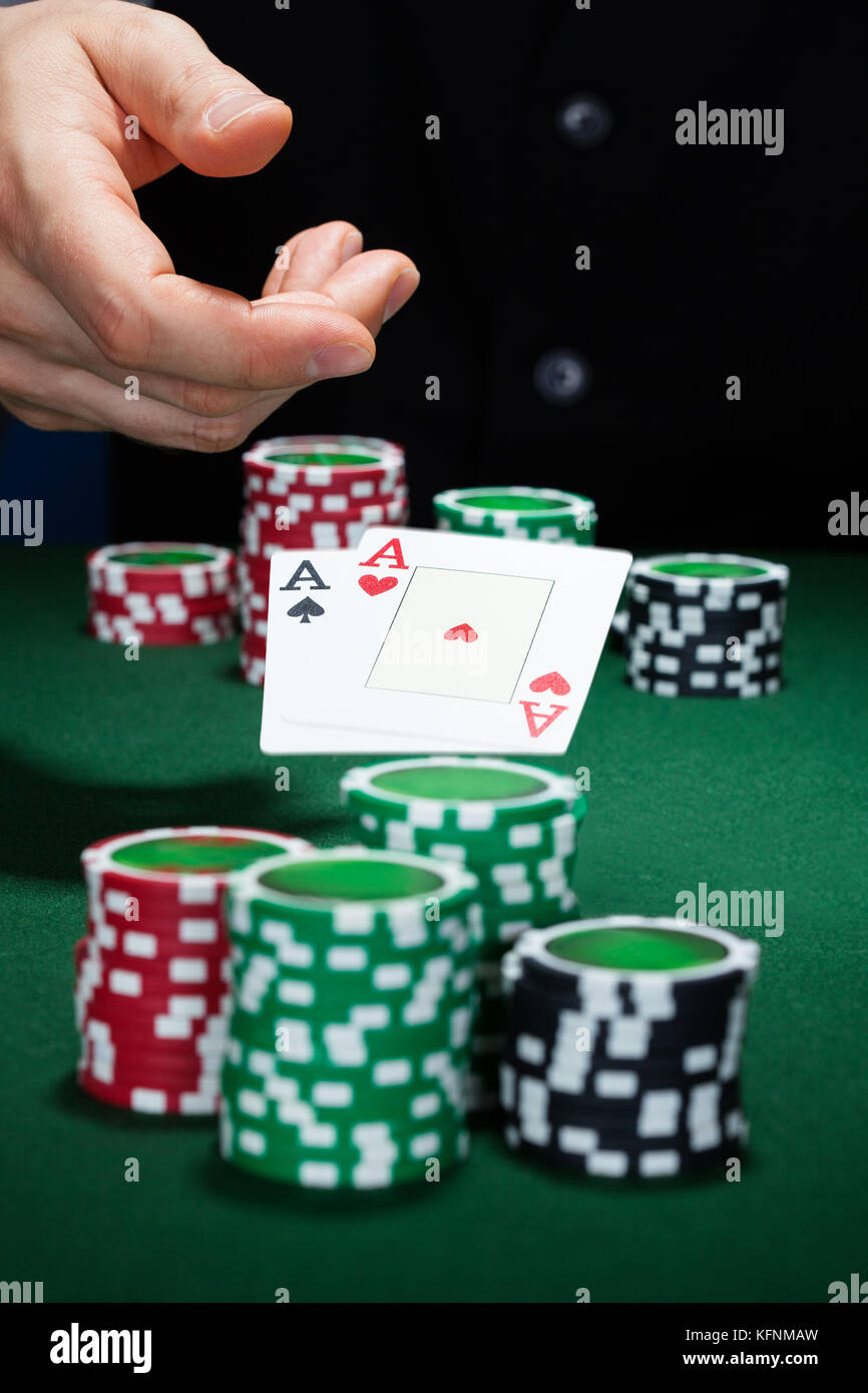 Close-up of hand with playing cards and gambling chips Stock Photo - Alamy