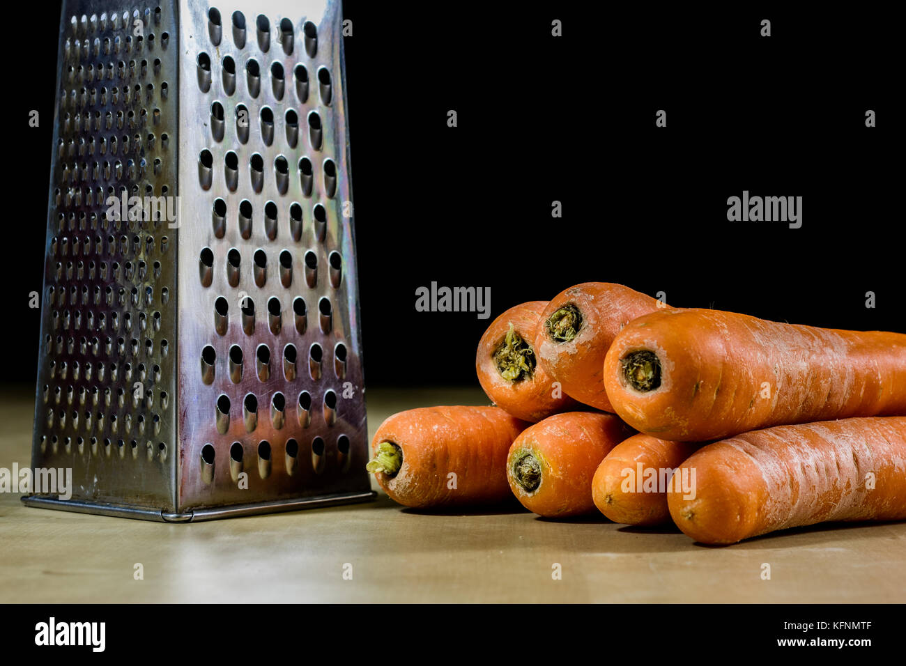 Carrot on the kitchen table. Vegetable grater. Kitchen table Stock ...