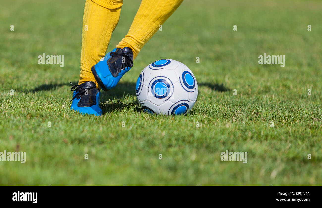 Close-up image of the feet of a soccer player dribbling Stock Photo - Alamy