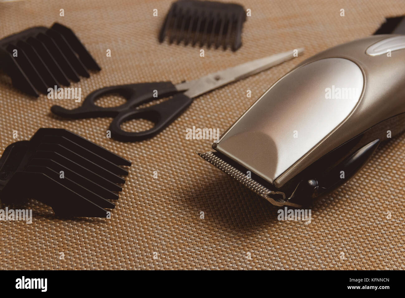 Stylish Professional Hair Clippers, accessories on brown background ...