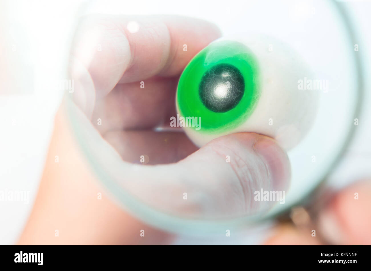 Examination of a silicone replica of an eye with magnifying glass Stock ...