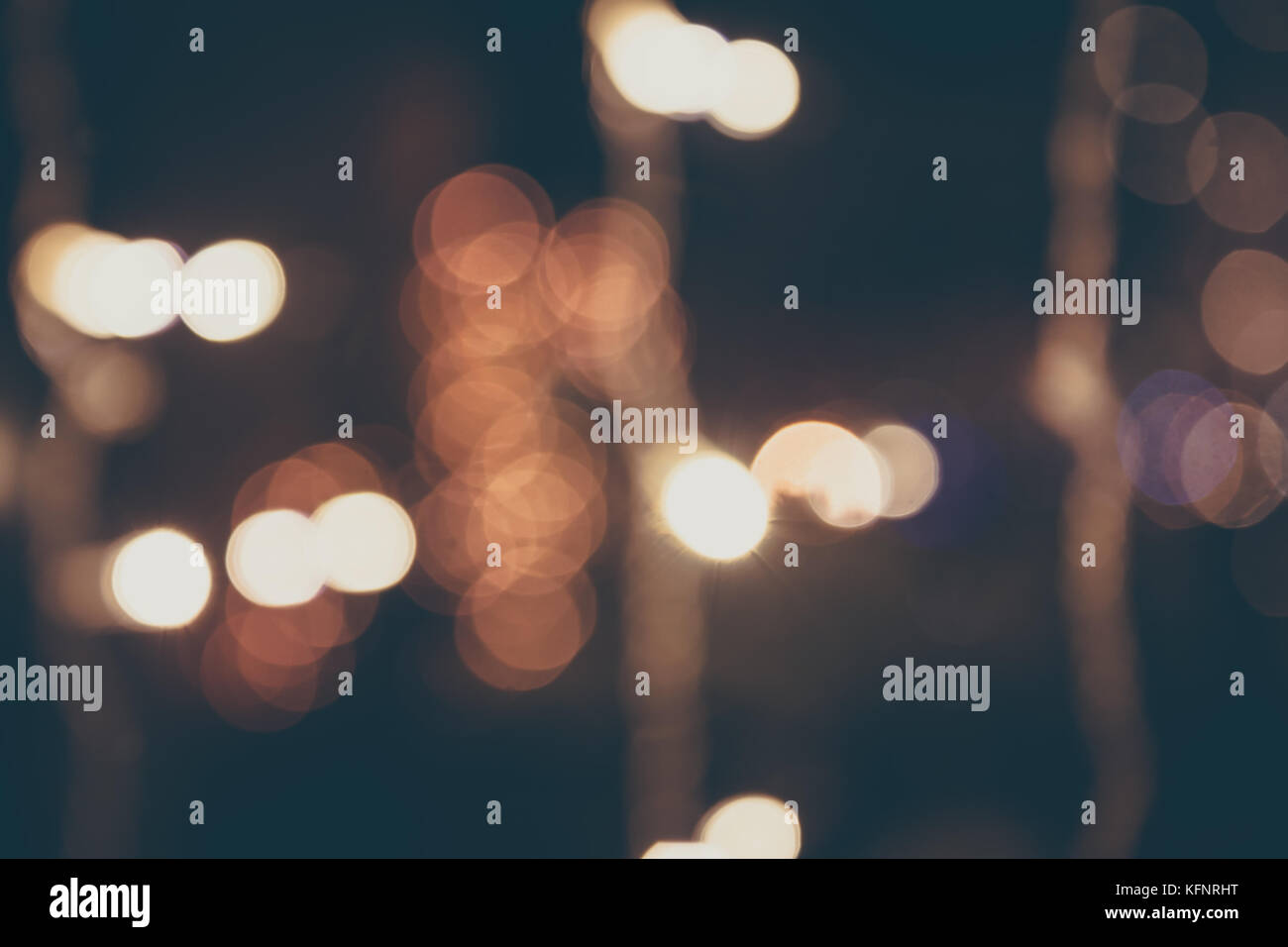 Retro blue toned blurred chrismas lights background with street lights ...