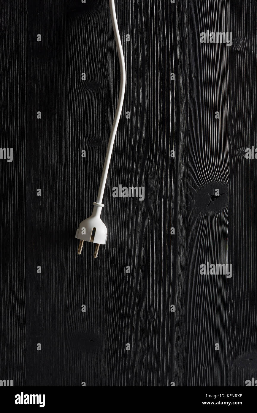power plug chord on dark wooden board Stock Photo - Alamy