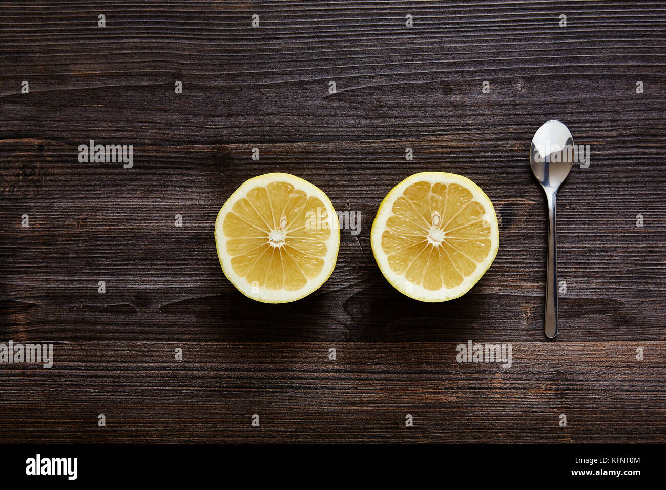 two slice citrus fruits with spoon Stock Photo - Alamy