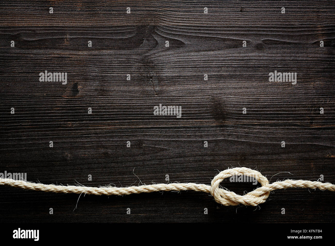 natural rope with knot on dark wood Stock Photo - Alamy
