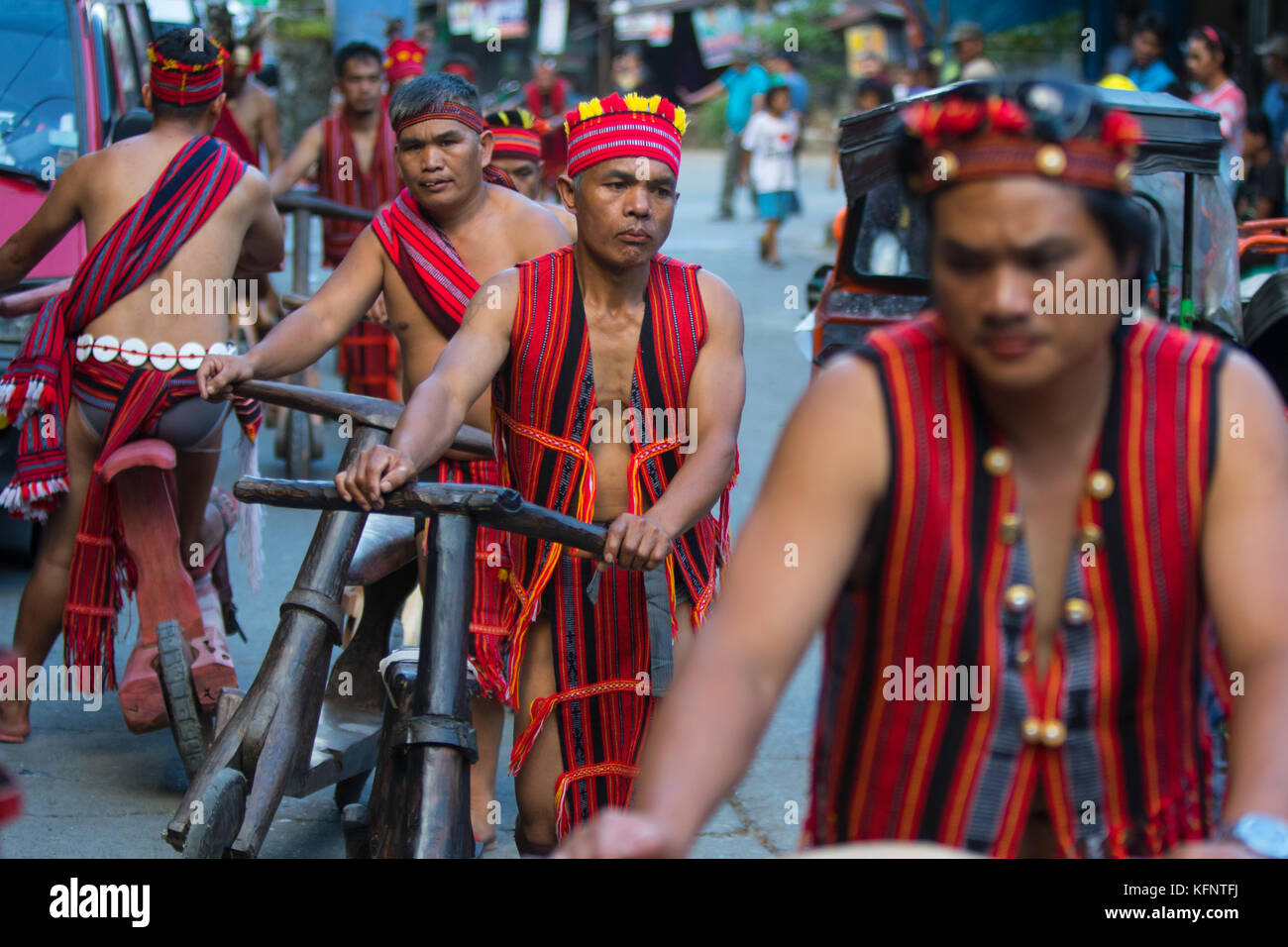 Ifugao men taking part in a wooden scooter race as part of the annual ...