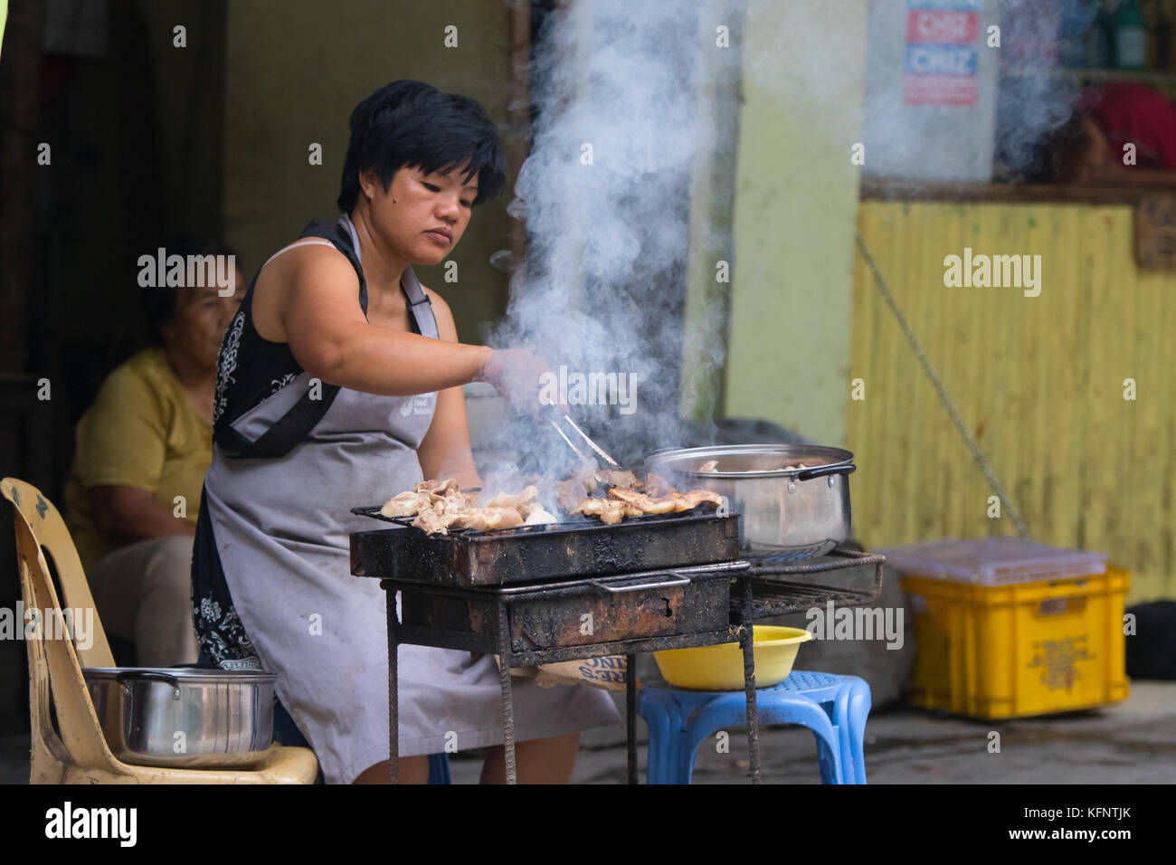 A Filipino woman cooking street food during the annual Imbayah Festival ...