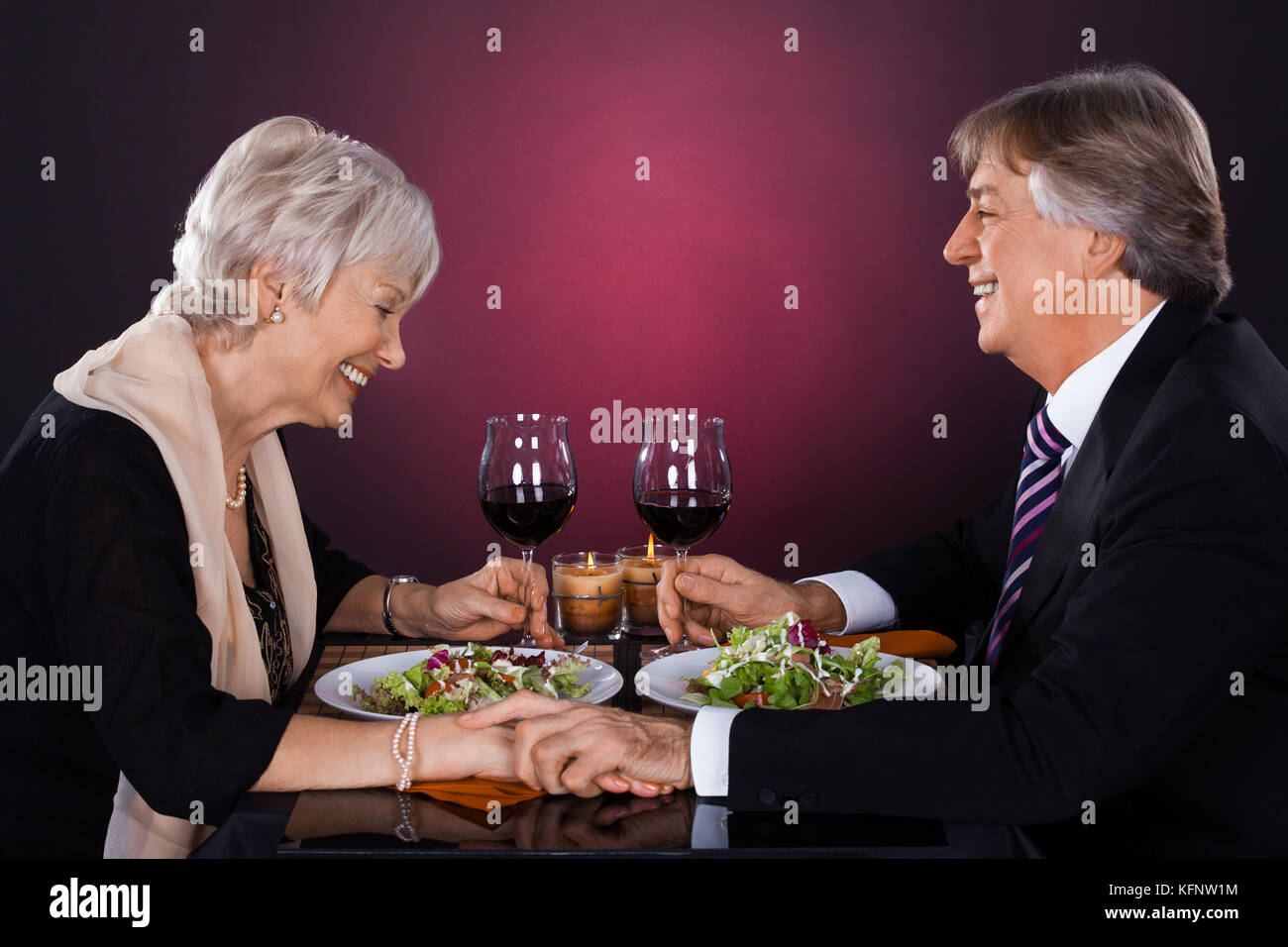 Happy Senior Couple Dining Together With Wine In A Restaurant Stock ...