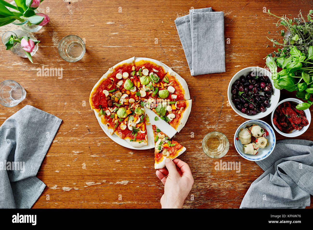 person taking first slice out of organic delicious pizza Stock Photo ...