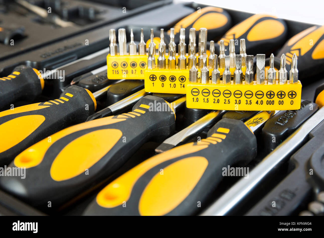 Set of screwdrivers in a box with rubber black and yellow handles. Bits ...