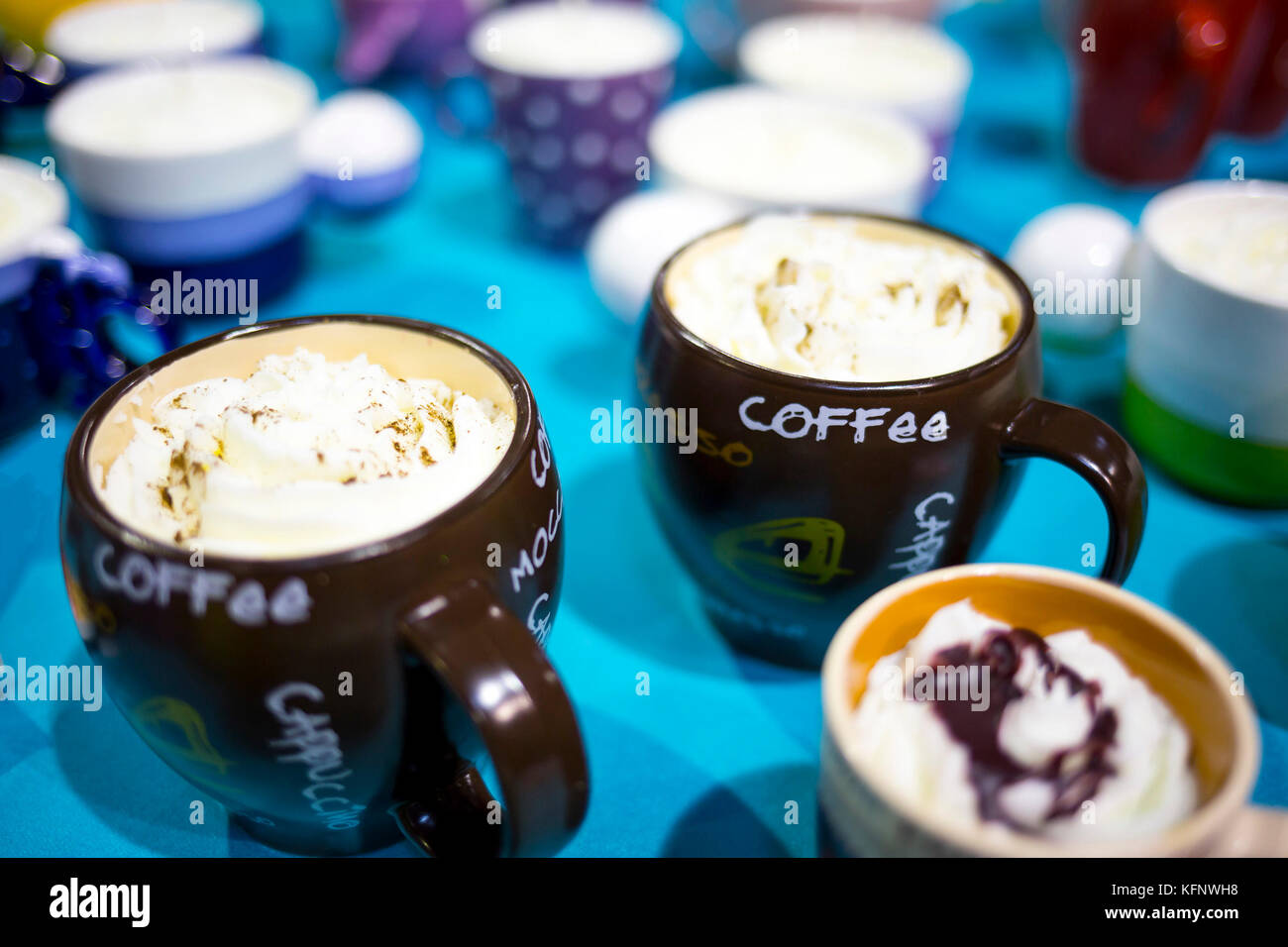 Cups of coffee with cream on top. Espresso latte with cinnamon and ...