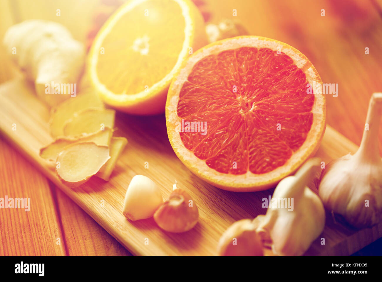 grapefruit, ginger, garlic and orange on board Stock Photo - Alamy