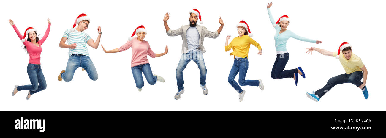 happy people in santa hats jumping in air Stock Photo - Alamy