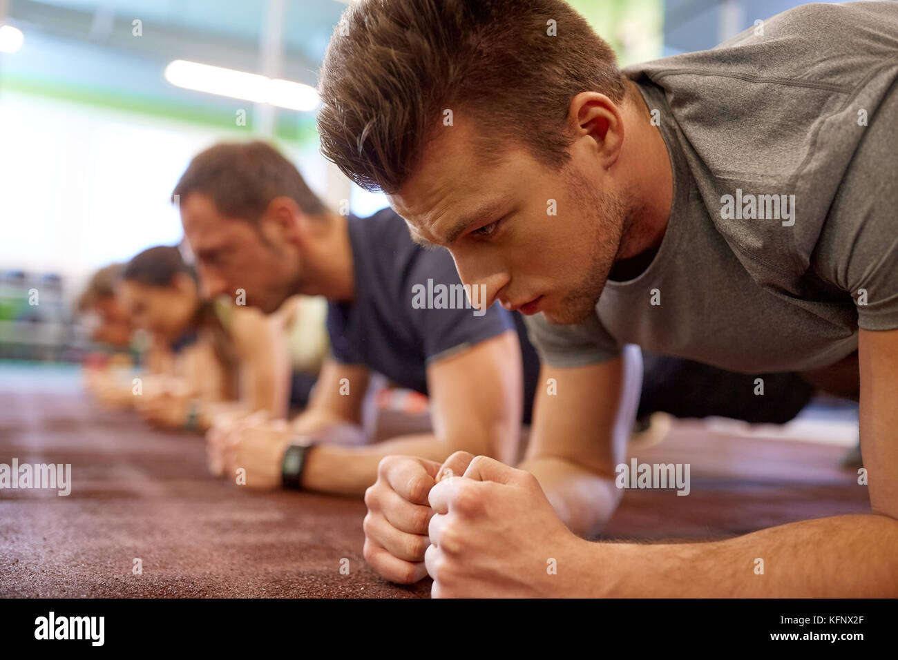 man doing plank exercise at group training in gym Stock Photo - Alamy