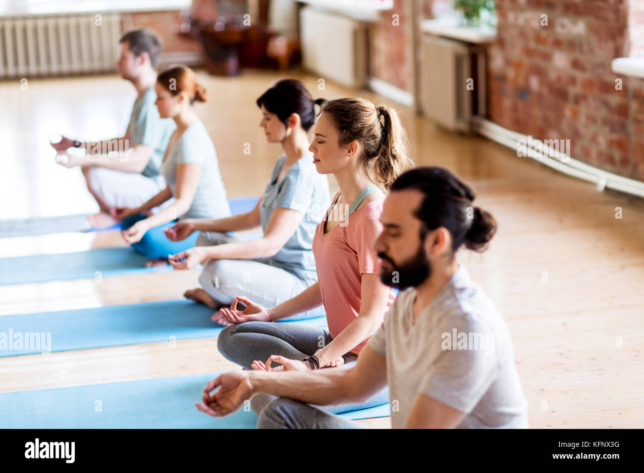 group of people making yoga exercises at studio Stock Photo - Alamy