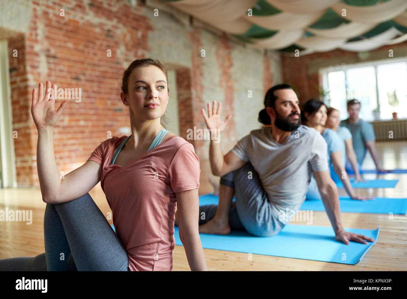 group of people doing yoga at studio Stock Photo - Alamy