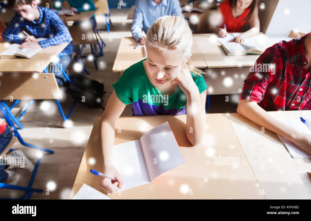 group of students with books writing school test Stock Photo - Alamy