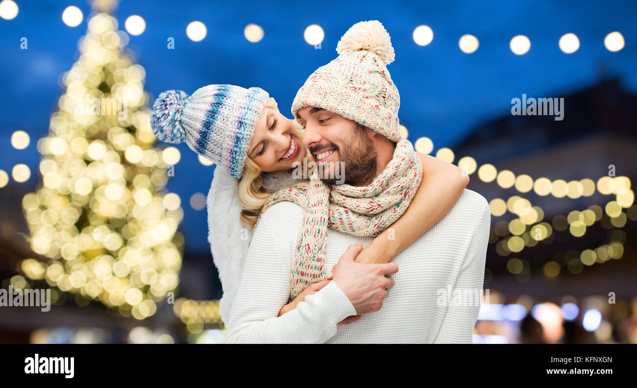 happy couple hugging over christmas tree lights Stock Photo - Alamy