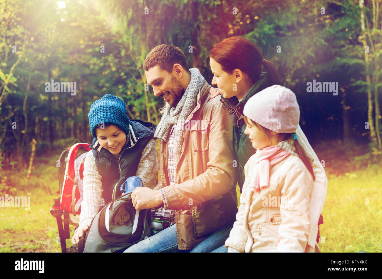 happy family with backpacks and thermos at camp Stock Photo - Alamy