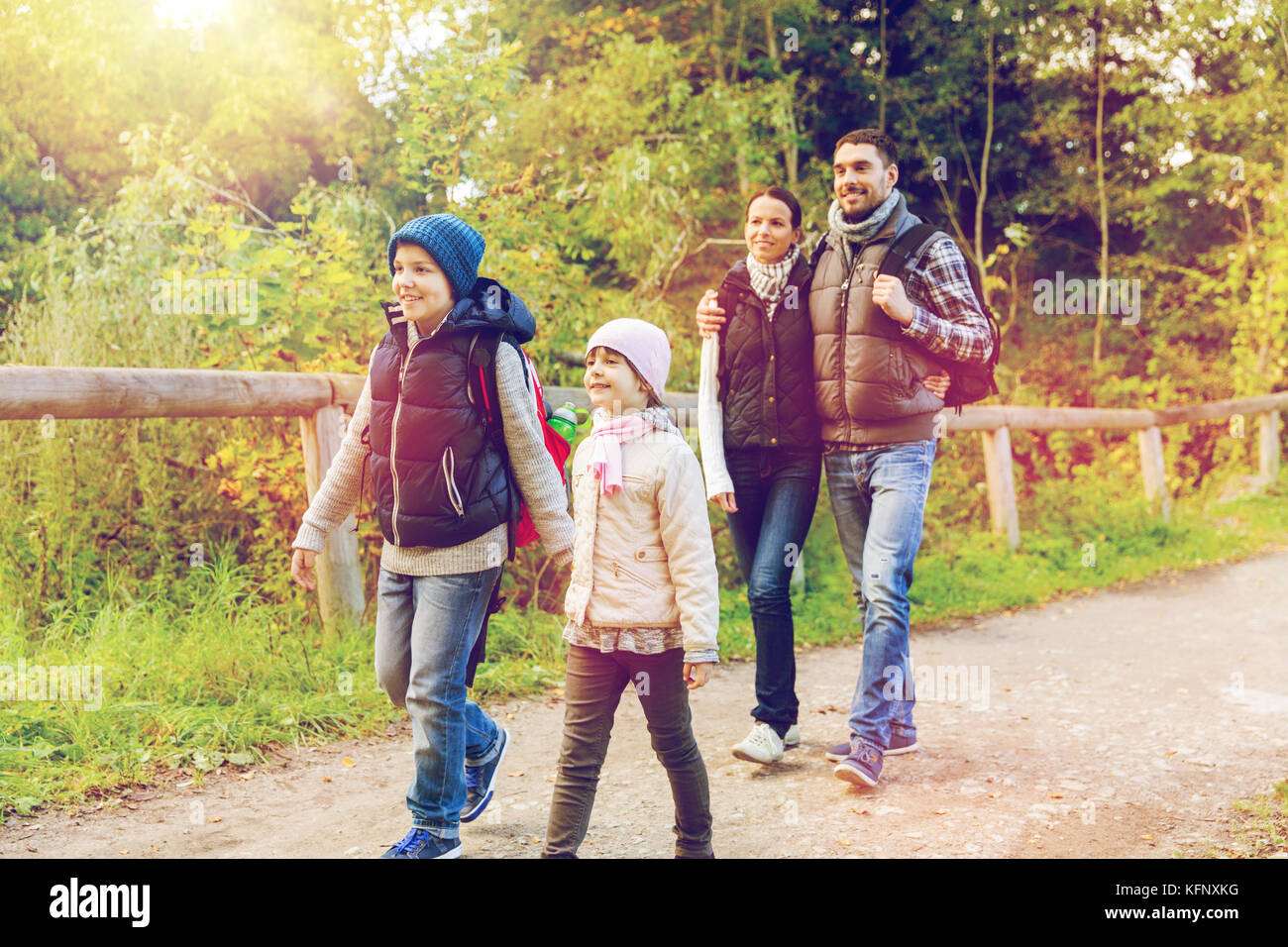 happy family with backpacks hiking in woods Stock Photo - Alamy
