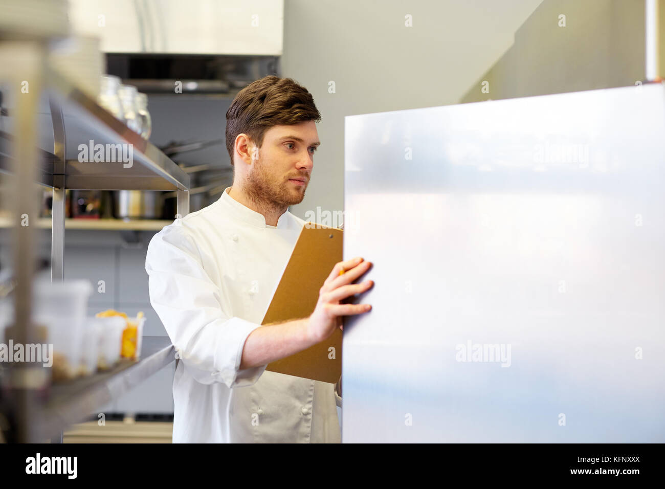 chef with clipboard doing inventory at kitchen Stock Photo - Alamy