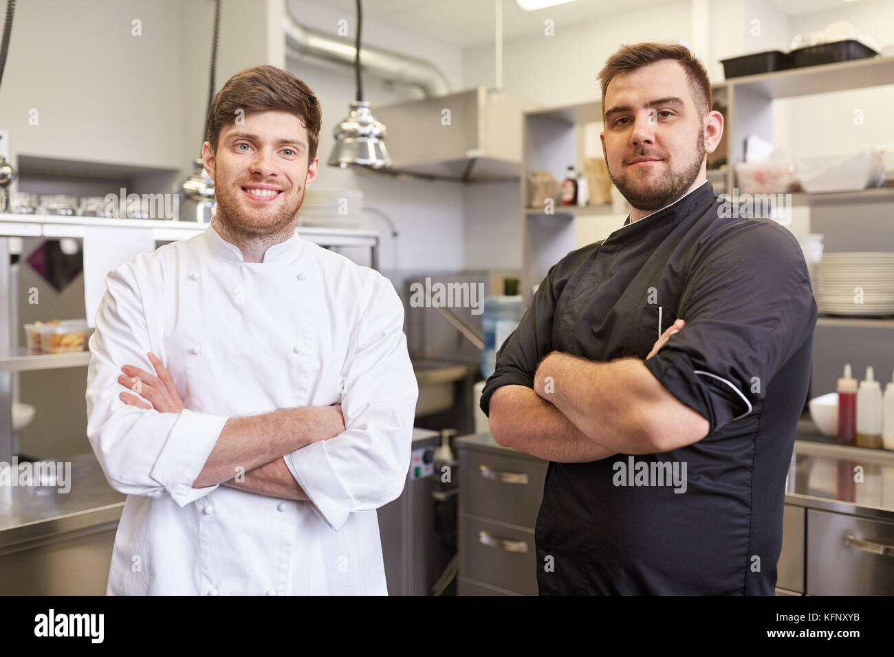happy smiling chef and cook at restaurant kitchen Stock Photo - Alamy