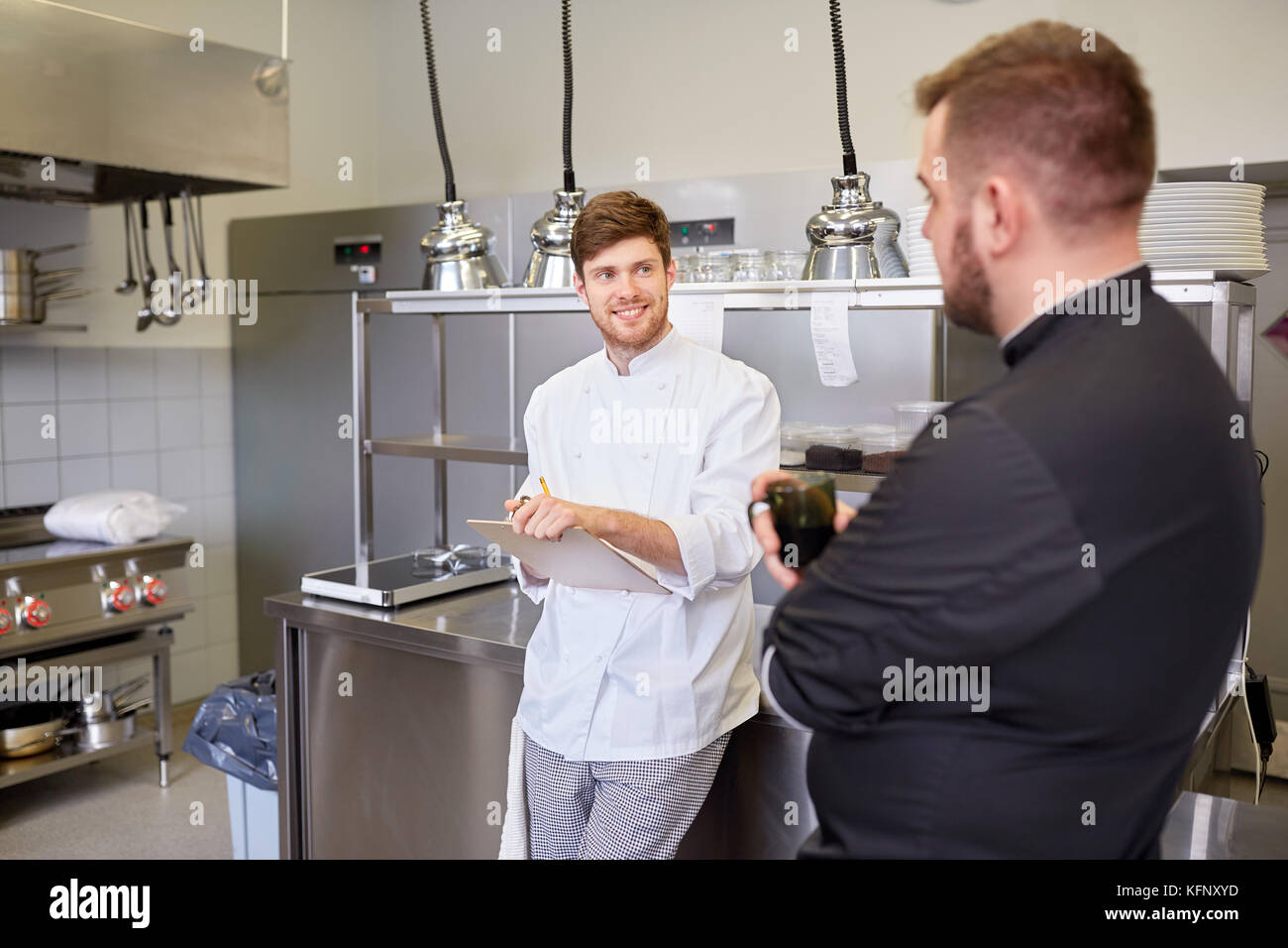 happy smiling chef and cook at restaurant kitchen Stock Photo - Alamy
