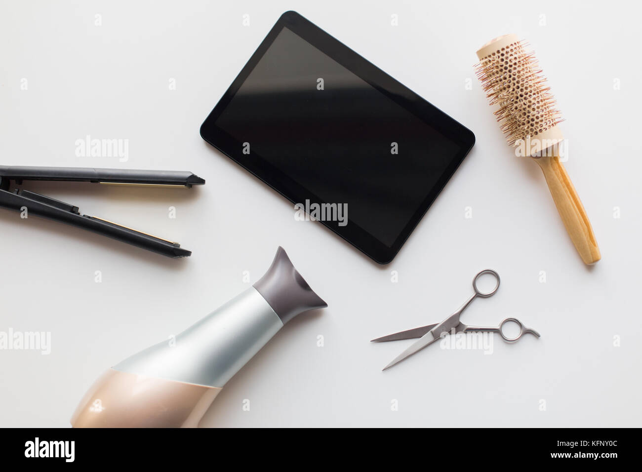 tablet pc, scissors, hairdryer, hot iron and brush Stock Photo - Alamy