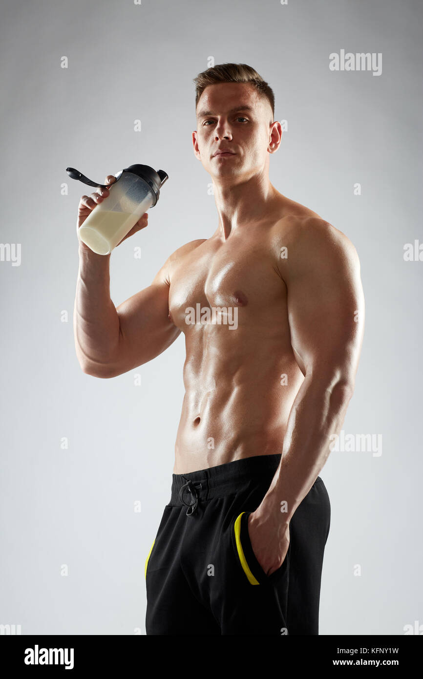 young man or bodybuilder with protein shake bottle Stock Photo - Alamy
