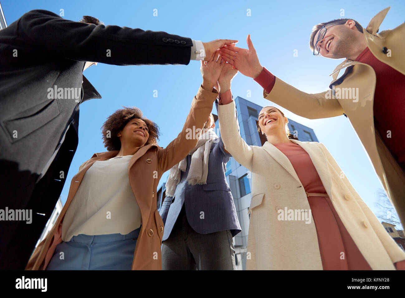 group of happy people making high five in city Stock Photo - Alamy