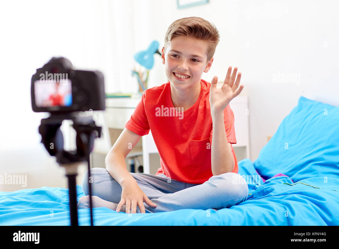 happy boy with camera recording video at home Stock Photo - Alamy