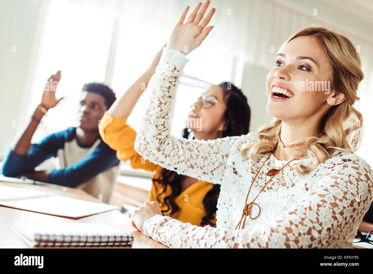 students raising hands in class Stock Photo - Alamy