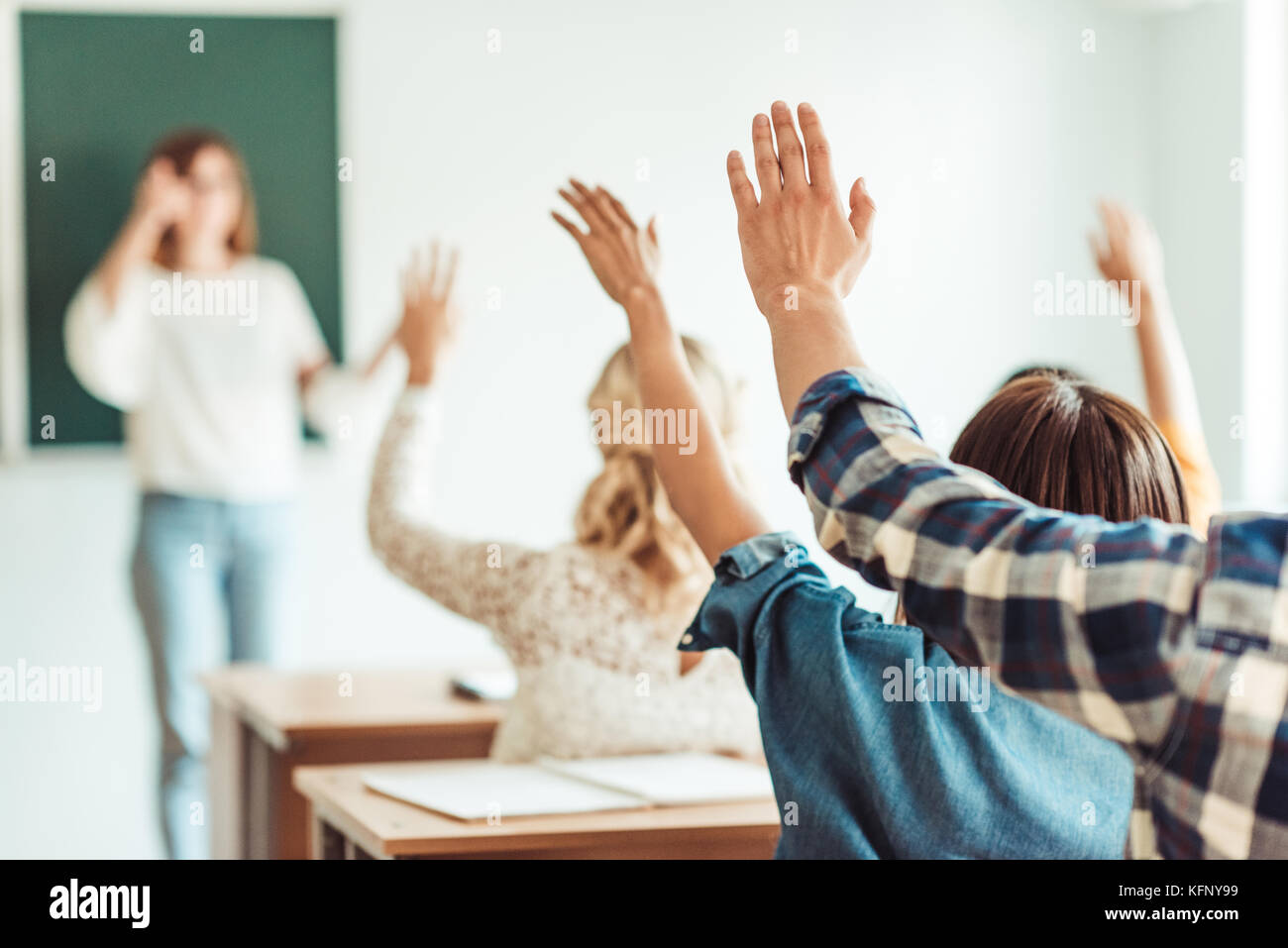 High school students raising hands hi-res stock photography and images ...