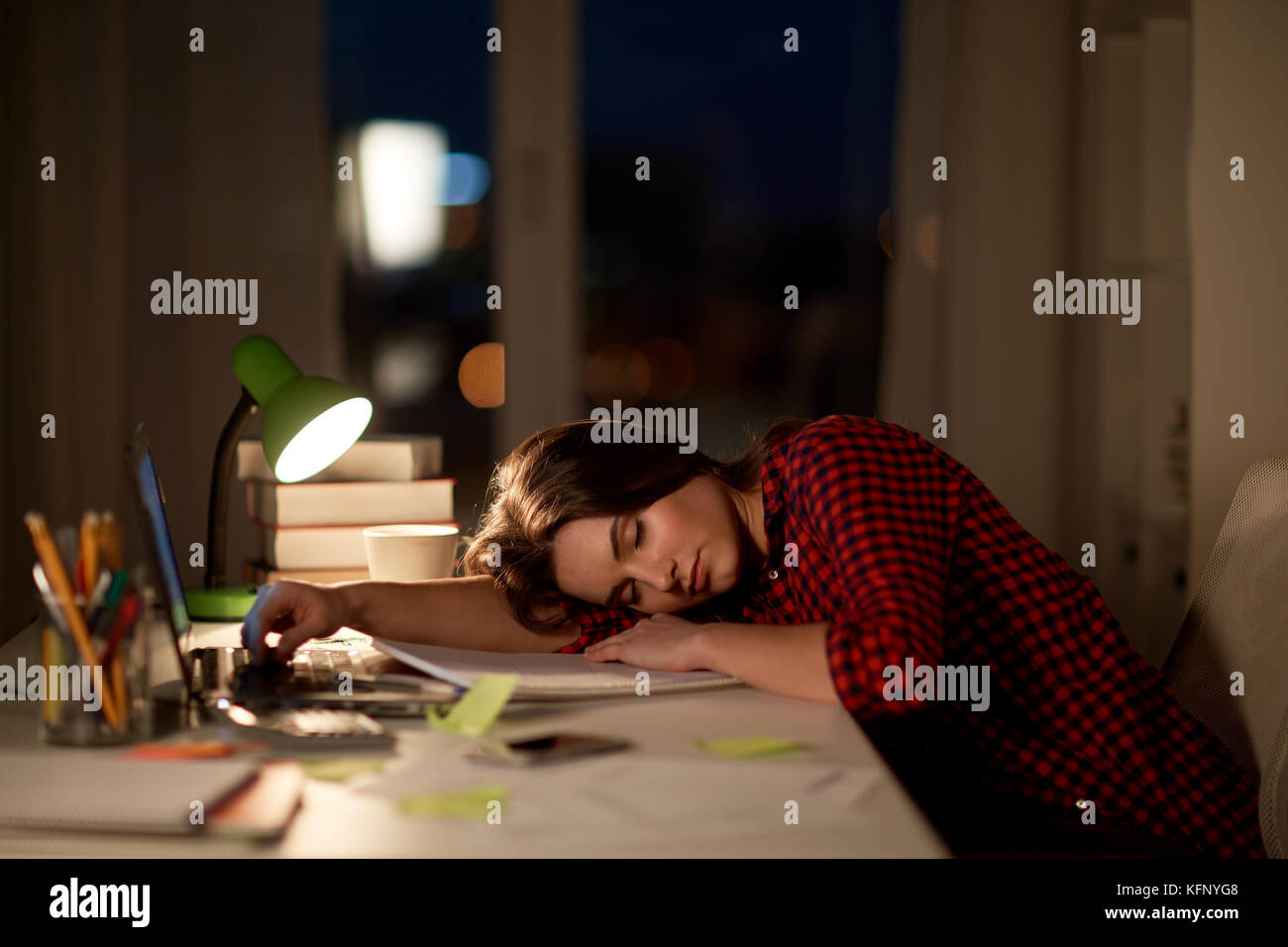 student or woman sleeping on table at night home Stock Photo - Alamy