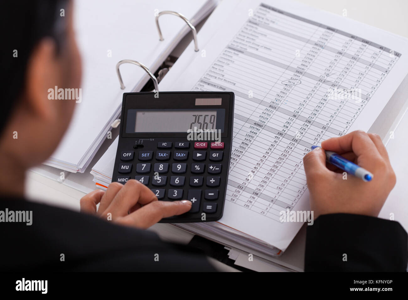 Young Businesswoman Doing Calculations In The Office Stock Photo - Alamy