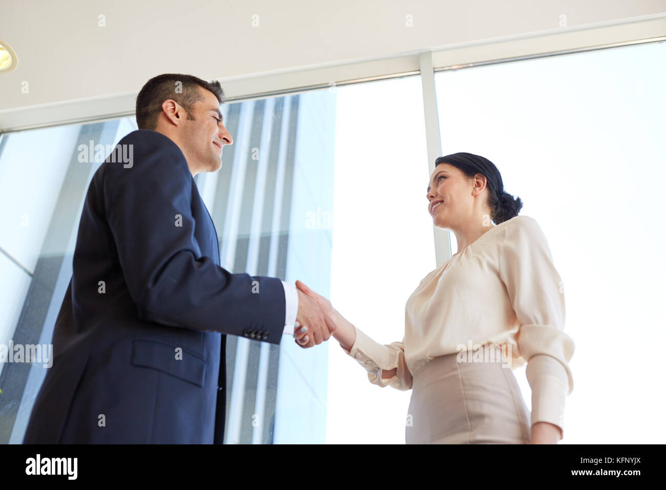 smiling business people shaking hands at office Stock Photo - Alamy