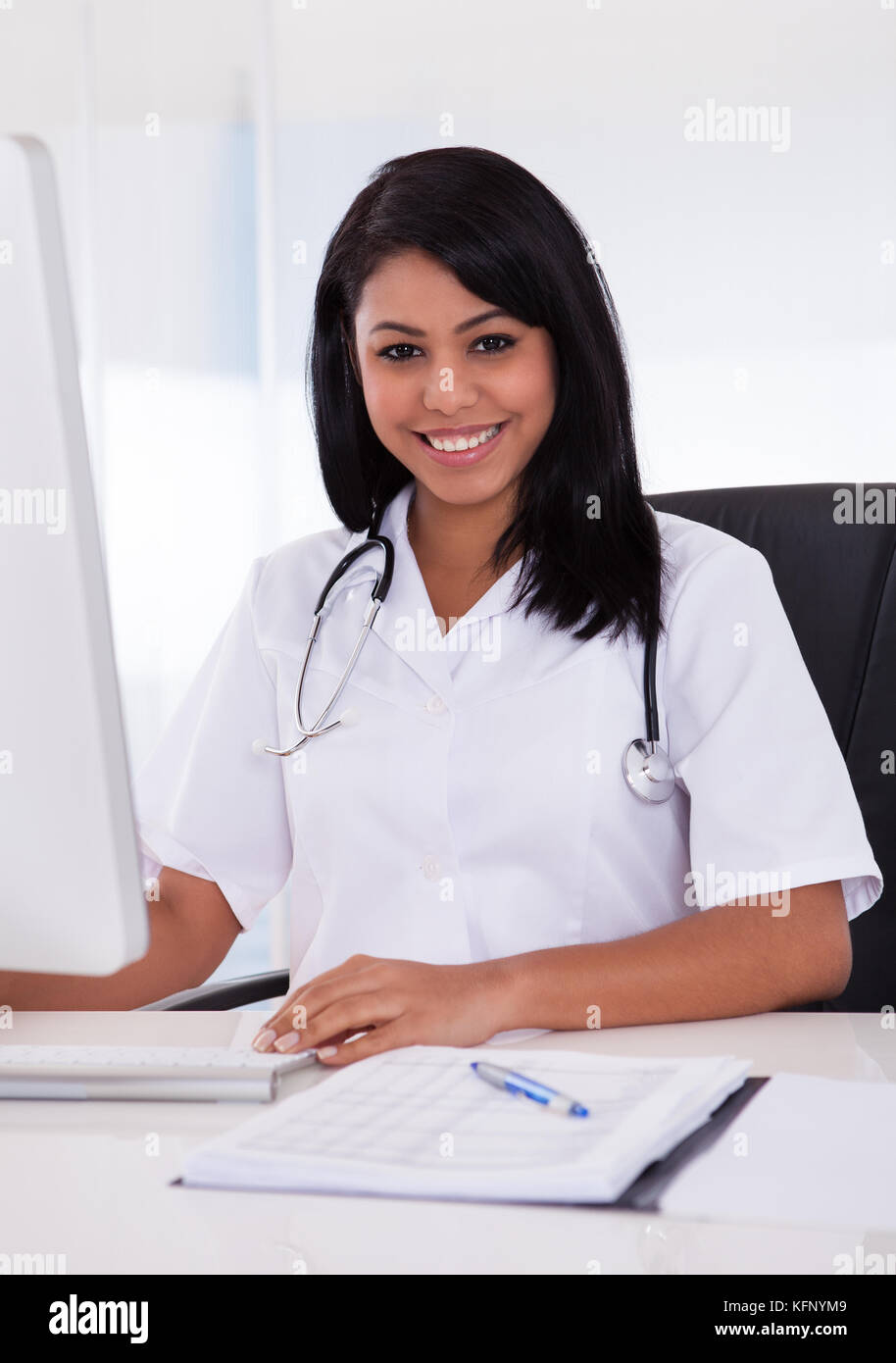 Pretty Young Confident Doctor Using Computer In Clinic Stock Photo - Alamy
