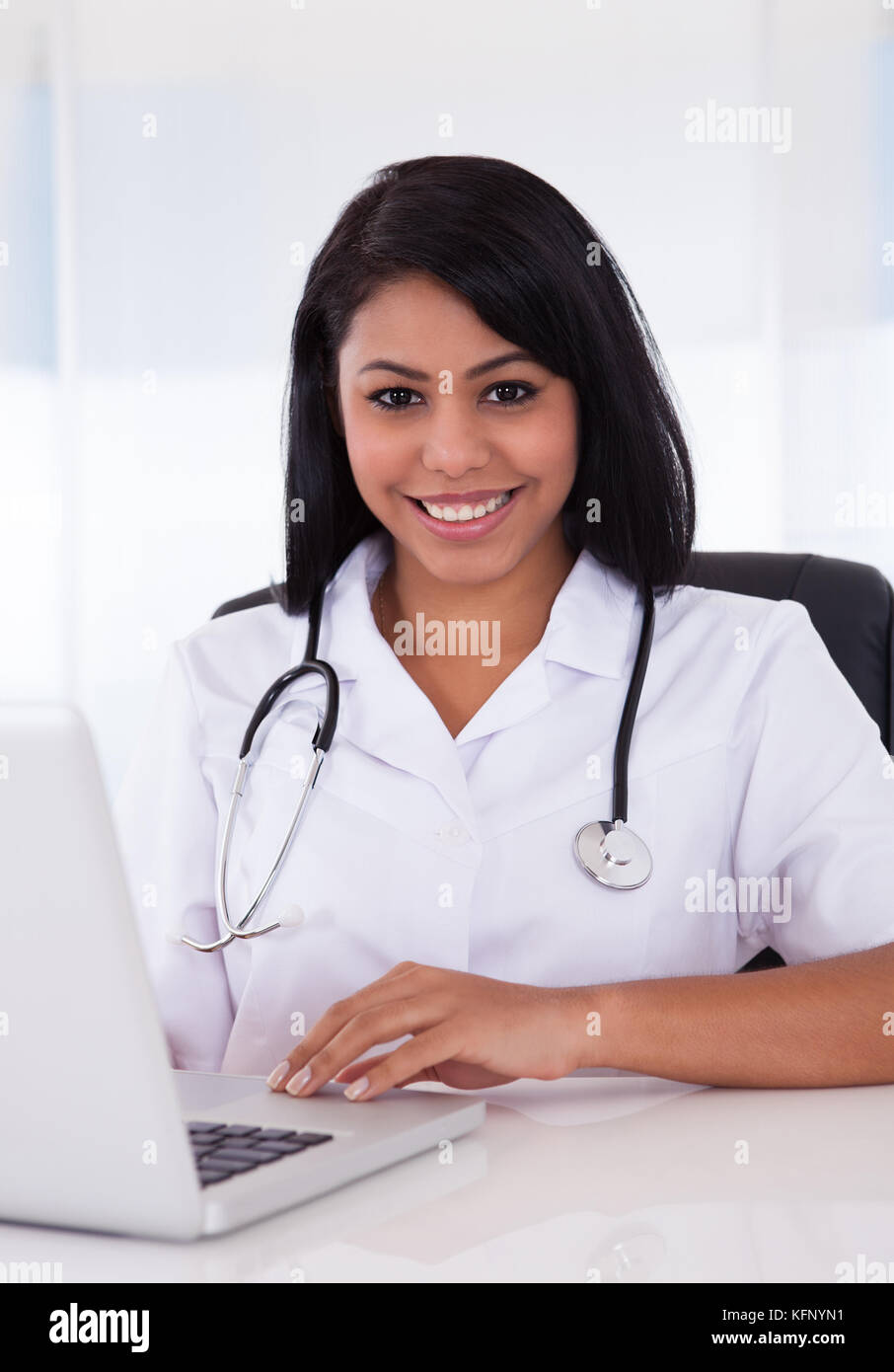 Pretty Young Confident Doctor Using Laptop In Clinic Stock Photo - Alamy