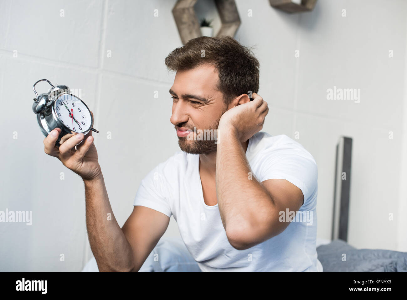 man holding alarm clock Stock Photo - Alamy