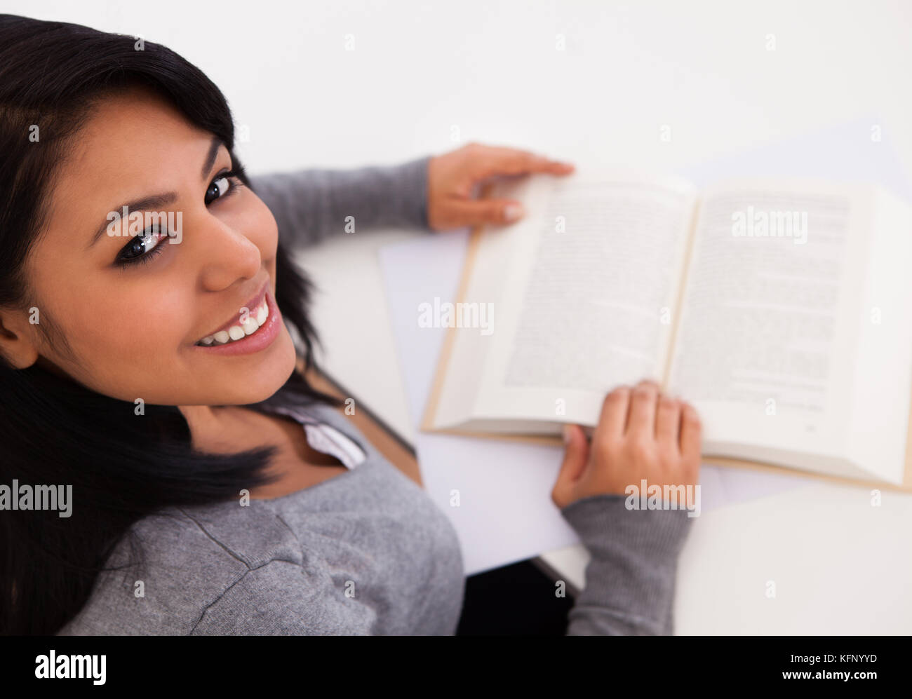 Young Happy Woman Reading Book At Home Stock Photo - Alamy