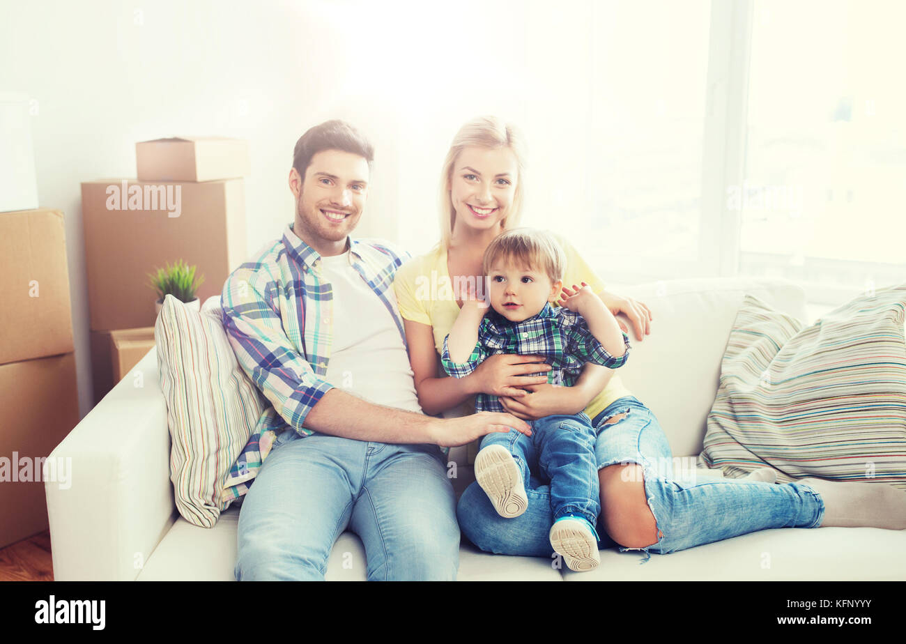 happy family with boxes moving to new home Stock Photo - Alamy