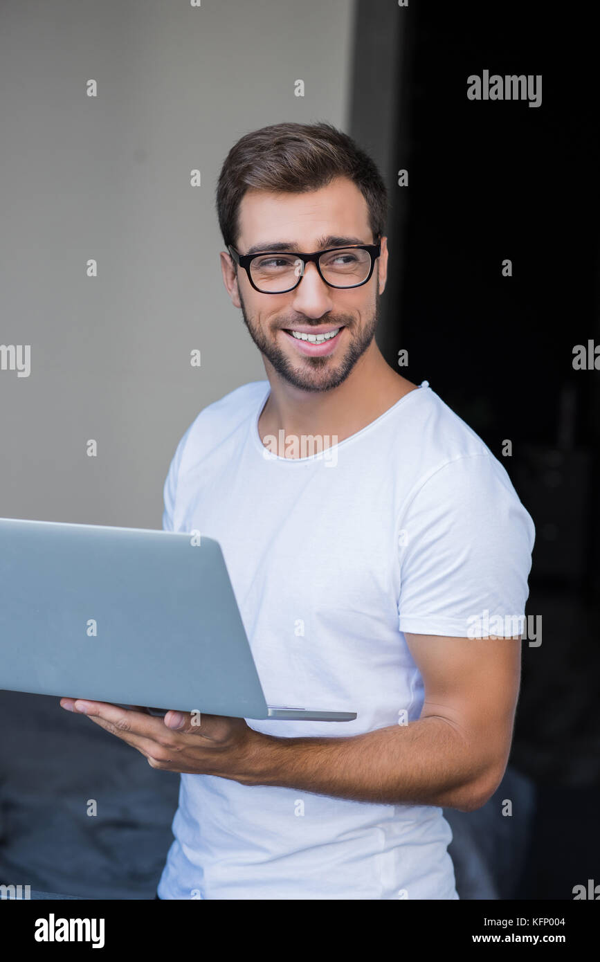 man holding laptop Stock Photo - Alamy