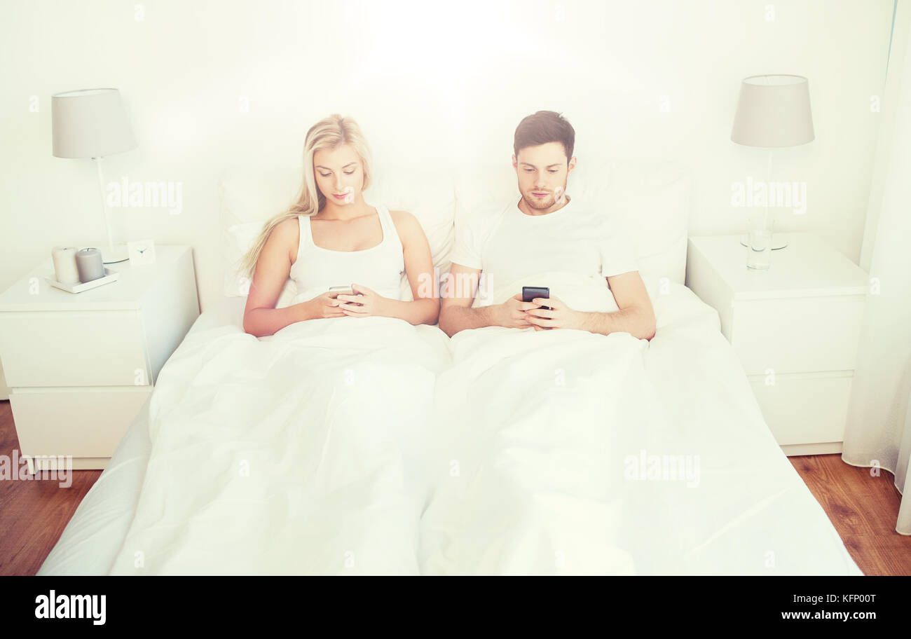 Teenage boy texting in bed hi-res stock photography and images - Alamy