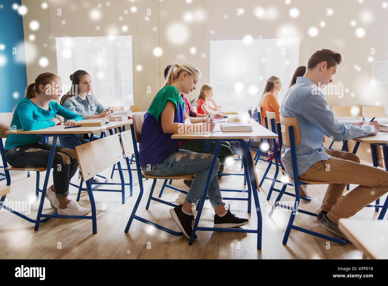 group of students with books writing school test Stock Photo - Alamy