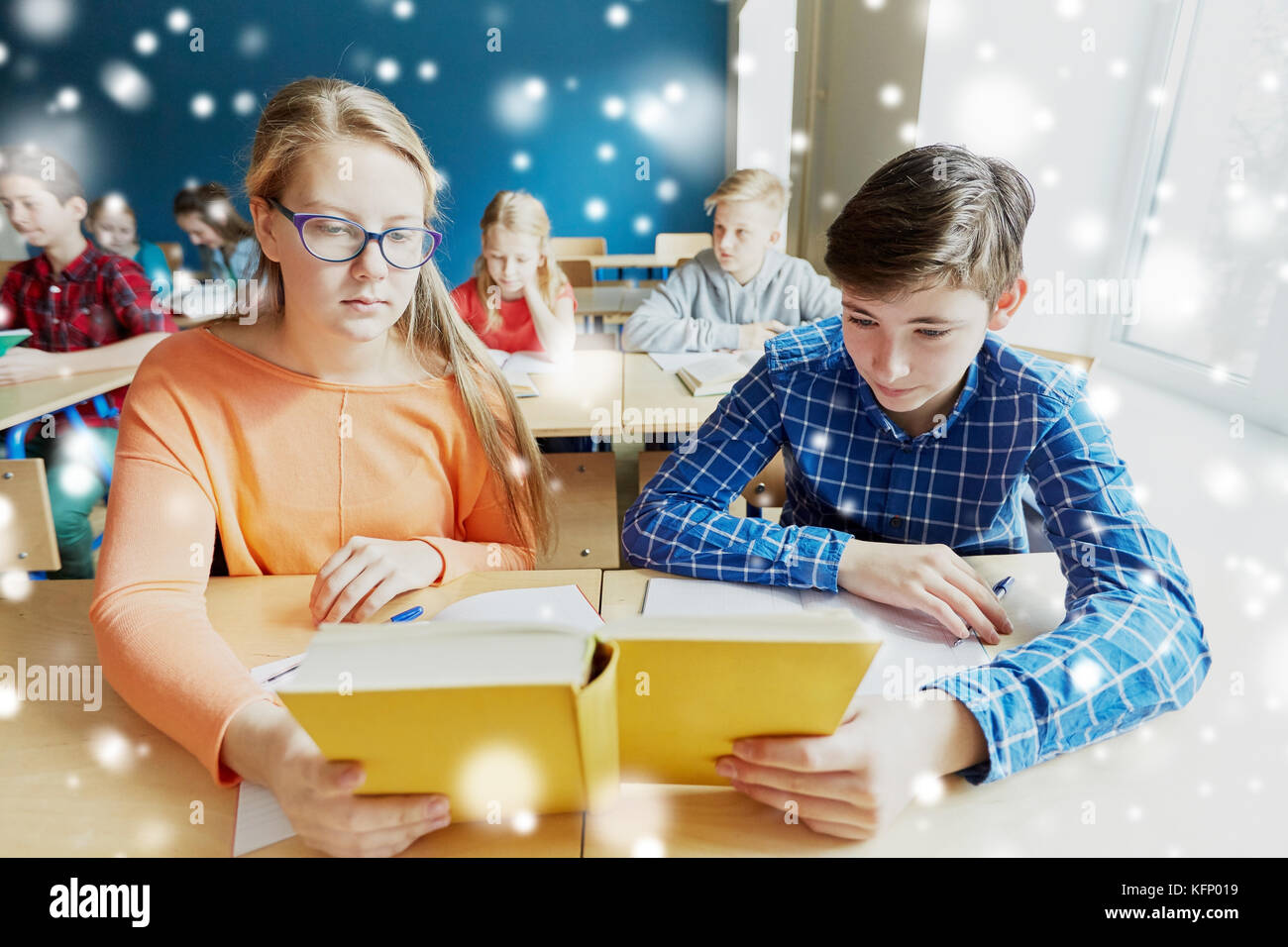students reading book at school lesson Stock Photo - Alamy