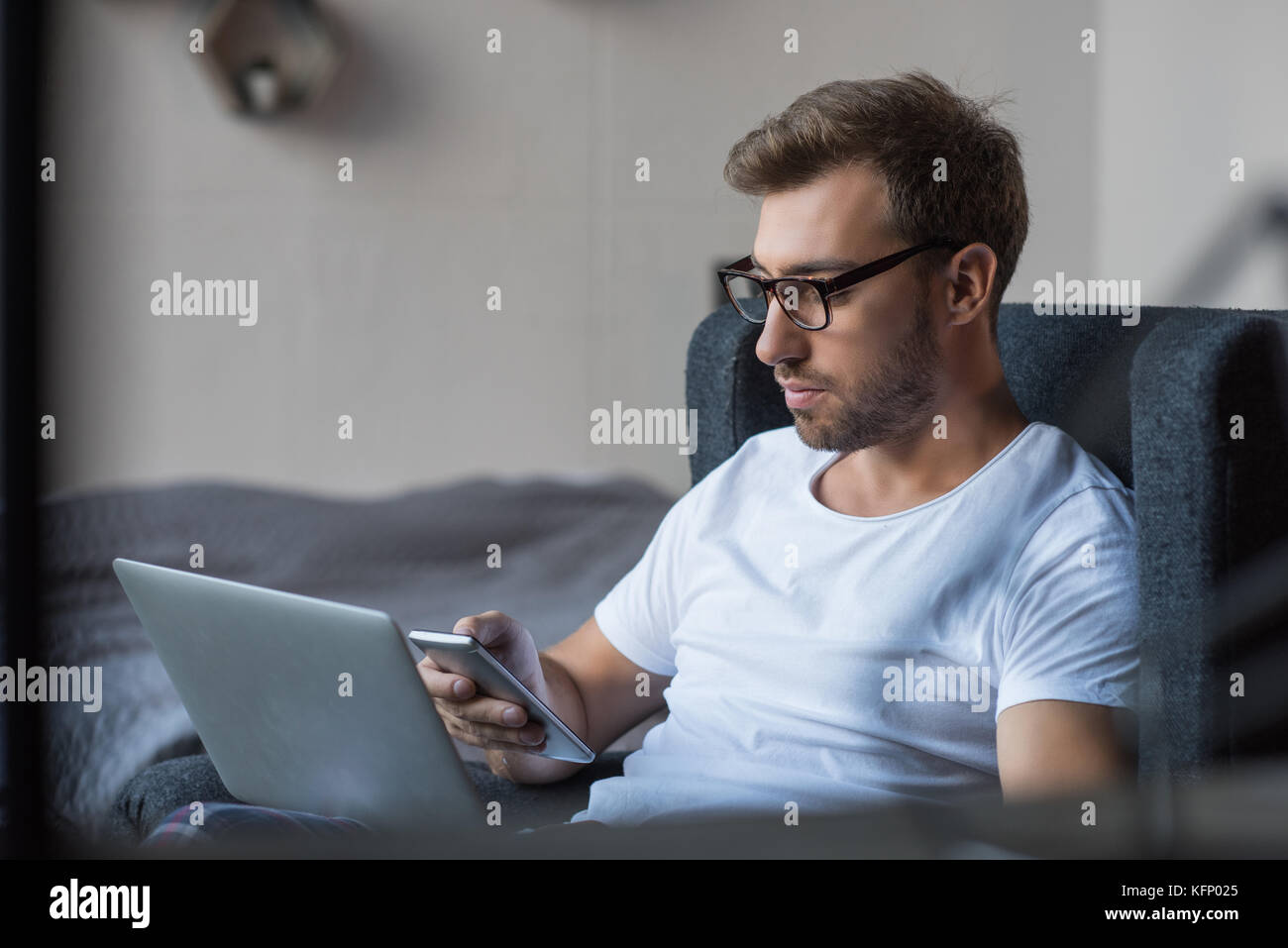 man with laptop using smartphone Stock Photo - Alamy