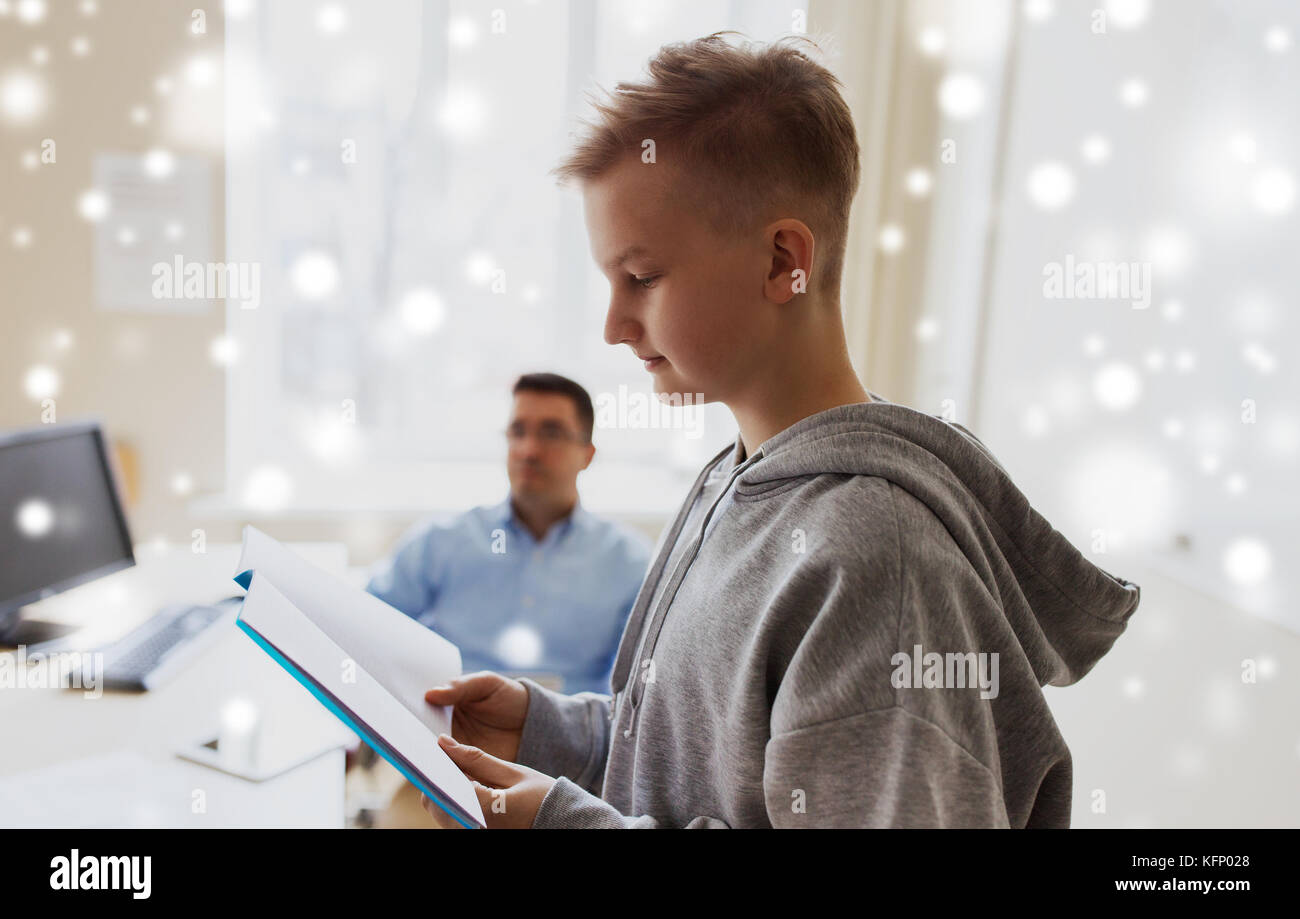 student boy with notebook and teacher at school Stock Photo - Alamy